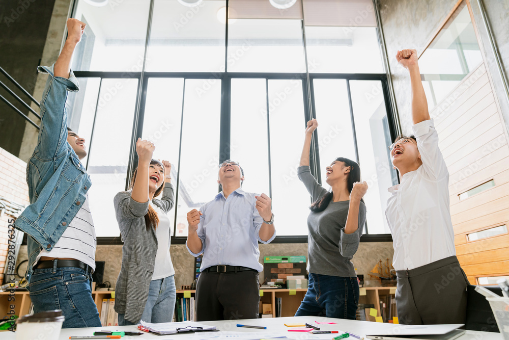 Cheerful group of creative business people winning great successful ...