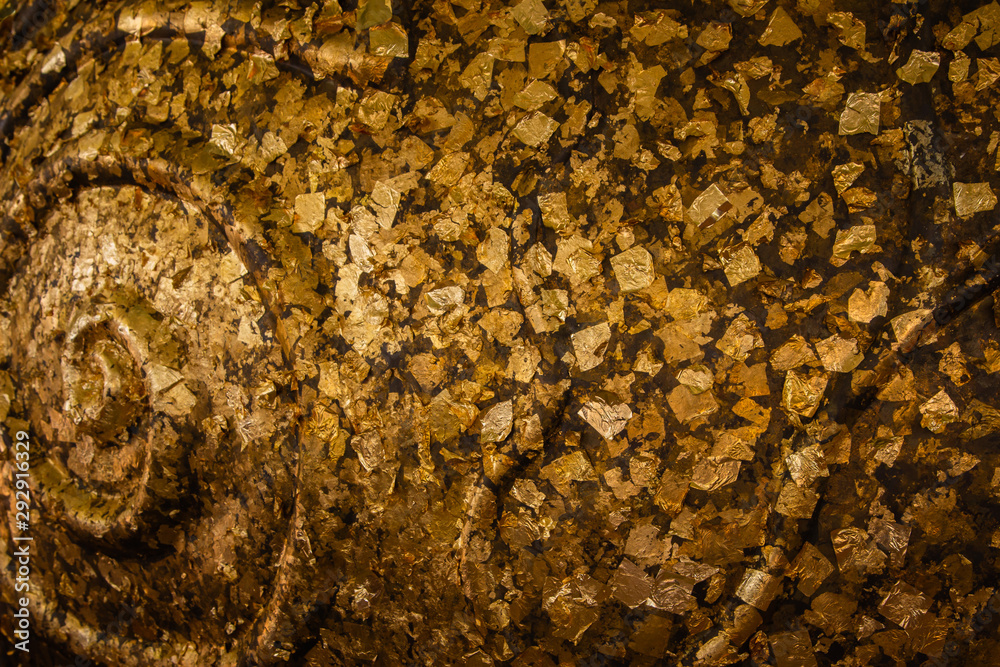 Gold leaf on the wall concrete surface background. Shiny yellow leaf ...