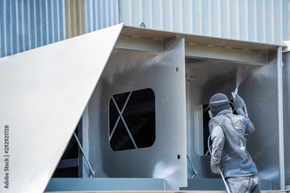 Airless Spray Painting, Worker painting on steel wall surface by ...