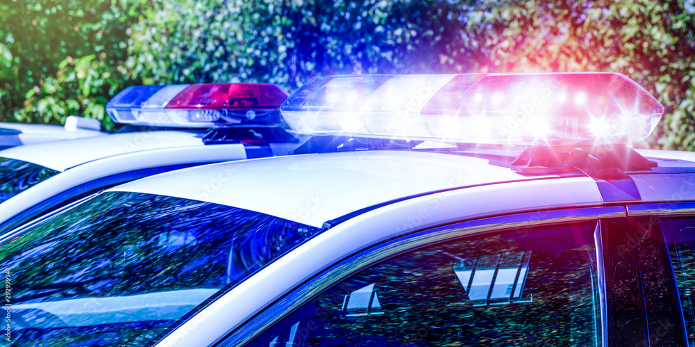 Police lights on car during traffic surveillance on the city road ...