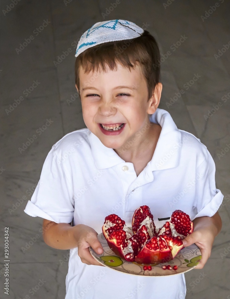 Cute adorable positive laughing Jewish Caucaisian boy with a kippah on ...