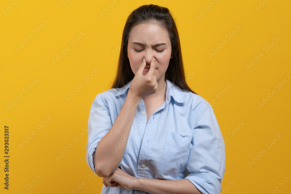 Face expression of human. Asian female smelling disgusted odor and ...