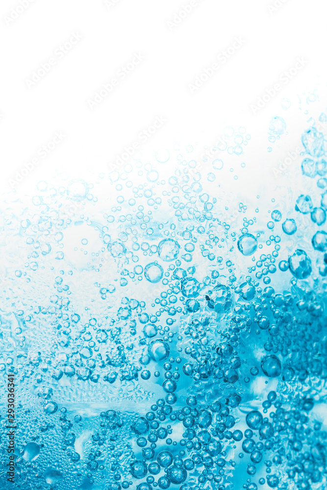 transparent background of soda water and ice with bright blue bubbles ...