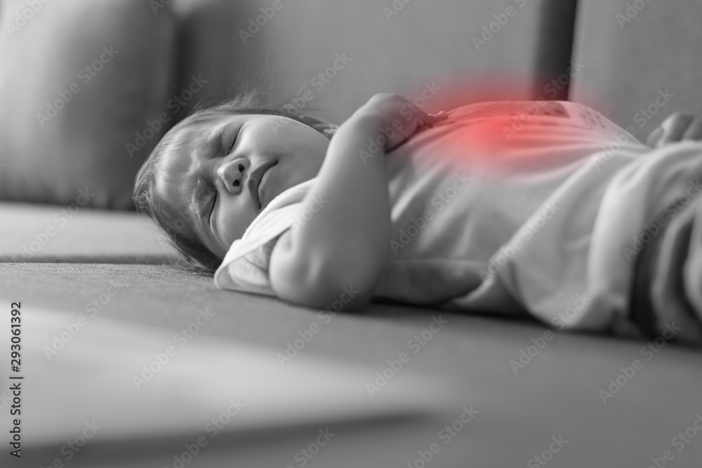 Young child suffering from a painful stomach ache. Stock Photo | Adobe ...