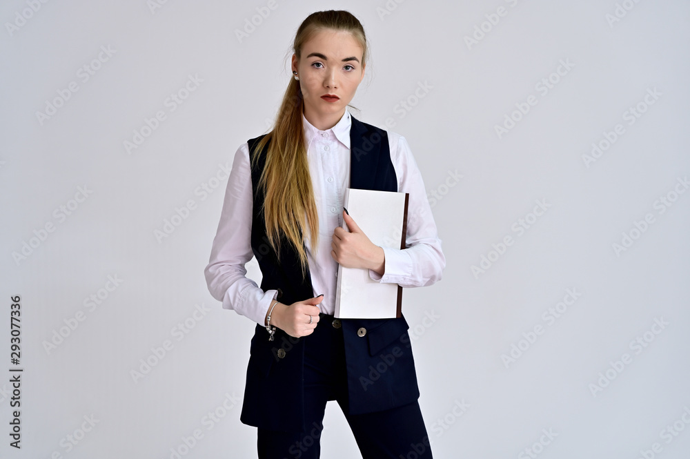 Portrait of a pretty manager girl in a business suit on a white ...