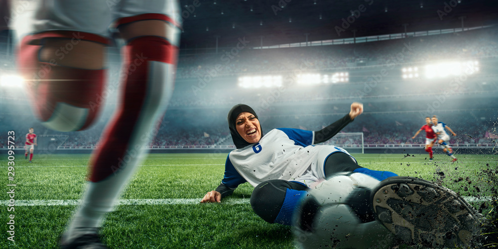 Female muslim soccer player in hijab shows exciting play during the ...