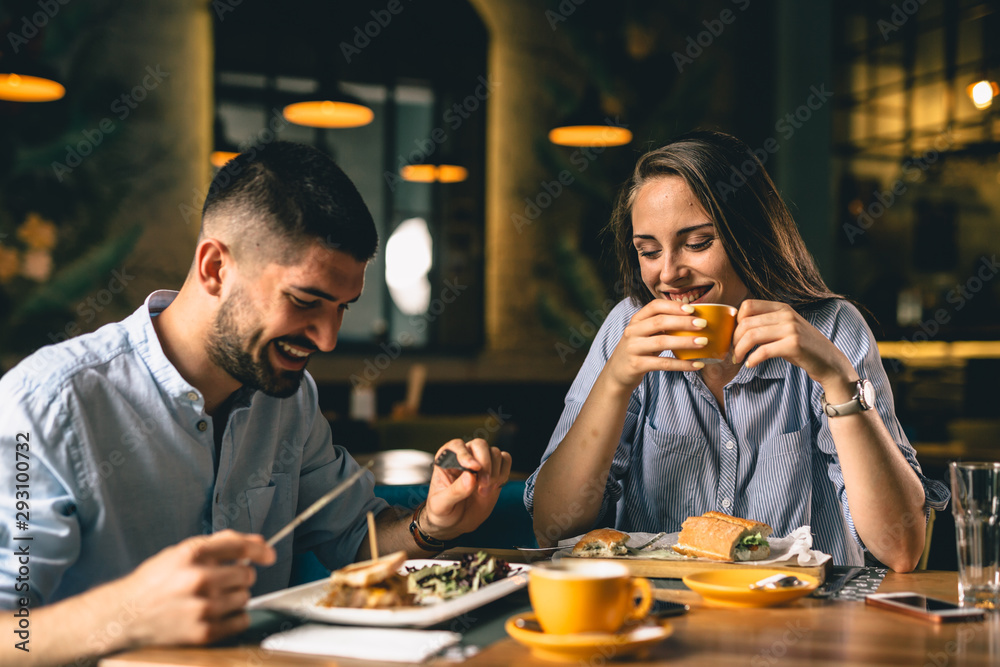 happy young couple eating in restaurant Stock Photo | Adobe Stock