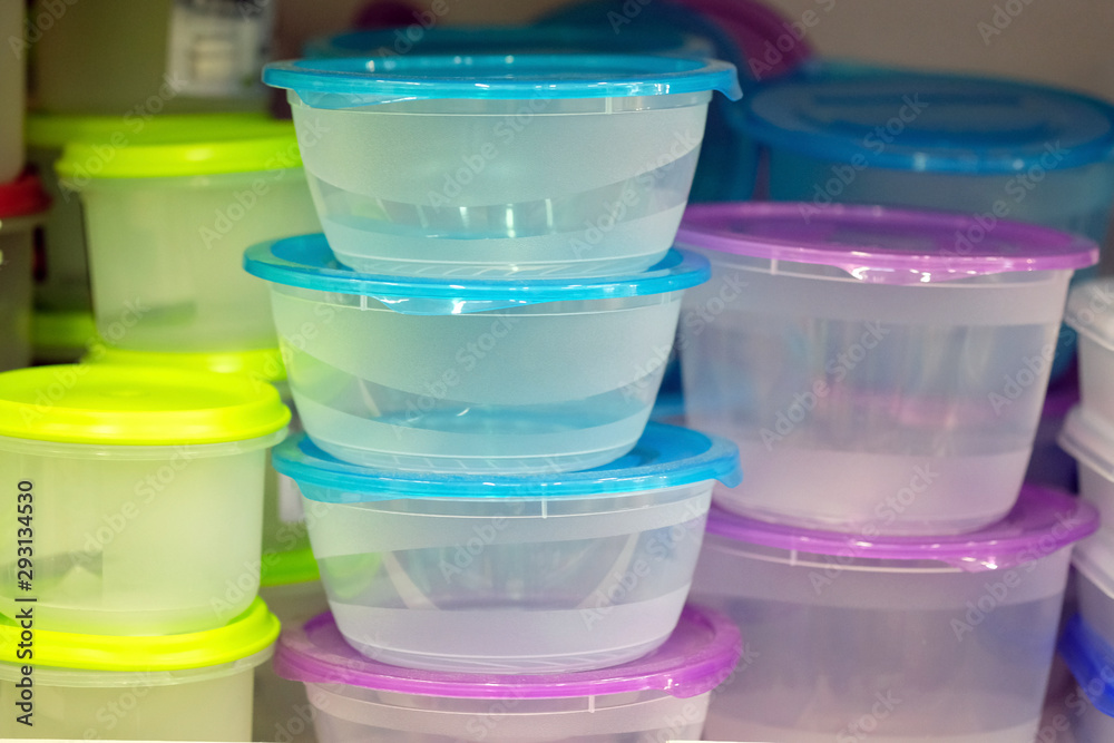 Plastic kitchen trays on the shelf of the kitchen cabinet. Round ...