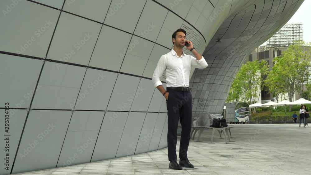 Wide shot of handsome and fit European man with dark hair in white ...