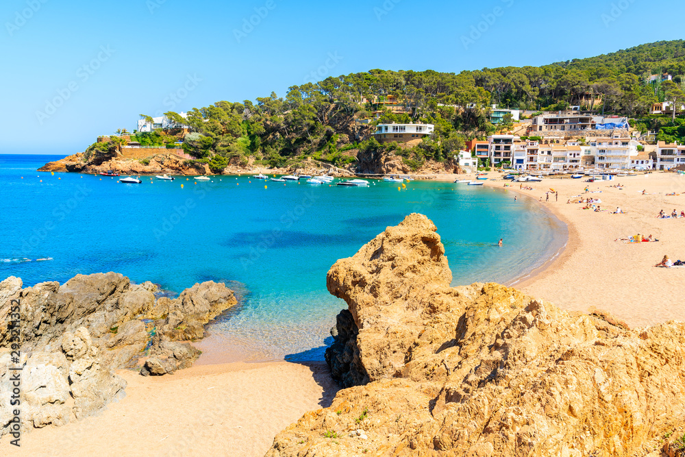 Rocks on stunning beach with azure sea water in beautiful Sa Riera ...