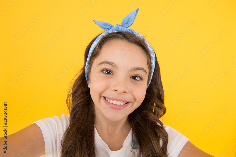 Smile like a model. Adorable small child with happy smile on yellow ...