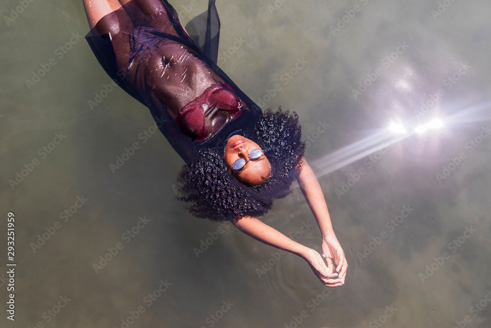 Black Woman Floating In Water