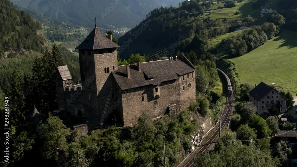 ancient austrian fortress schloss wiesberg with a train passing by ...