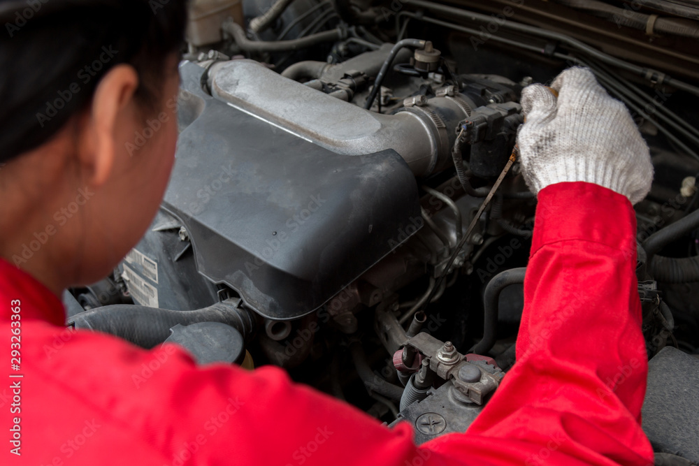 Mechanic in red overalls repairing the car engine, Concept of service ...