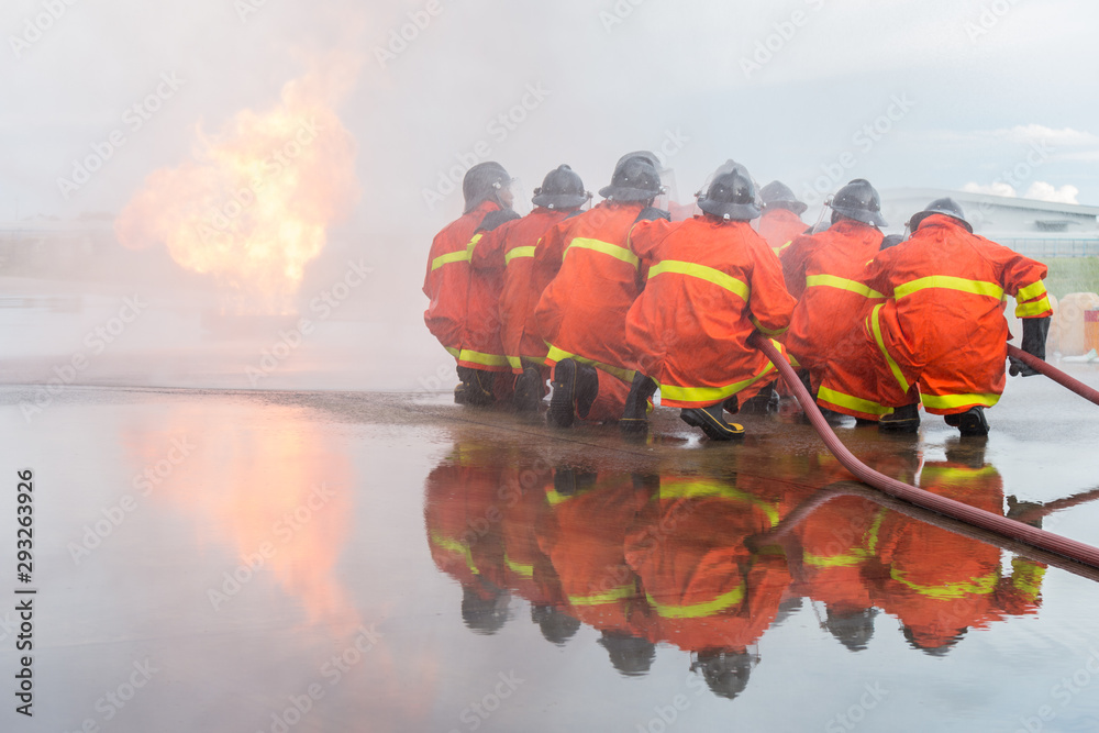 Group of Firefighters demonstration extinguish a fire during training ...