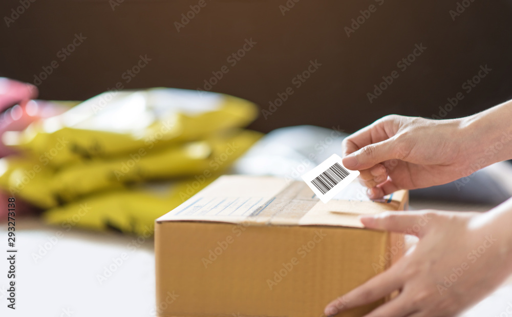 hand holding barcode label on shipping box Stock Photo | Adobe Stock