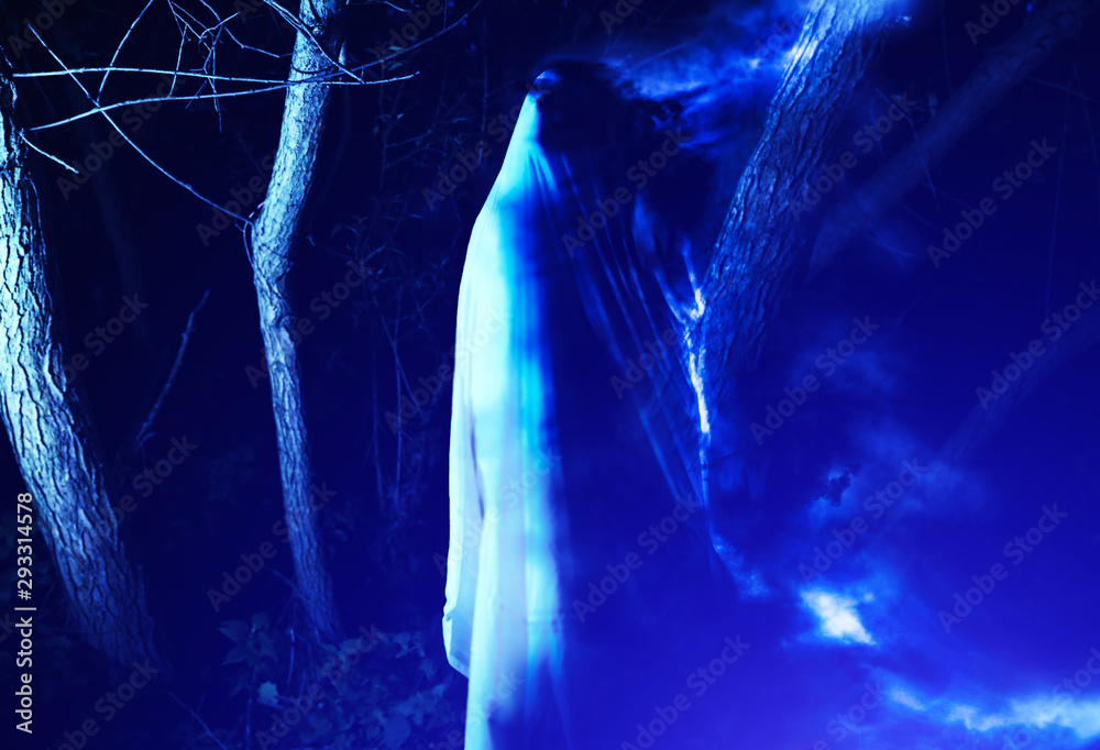 Ghost at night outdoors. Blue smoke around. Horror film concept. Scary ...