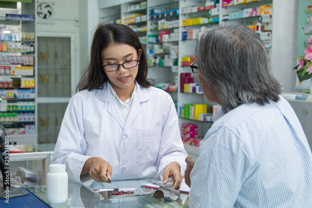 Young Asian attractive female pharmacist explaining details information ...