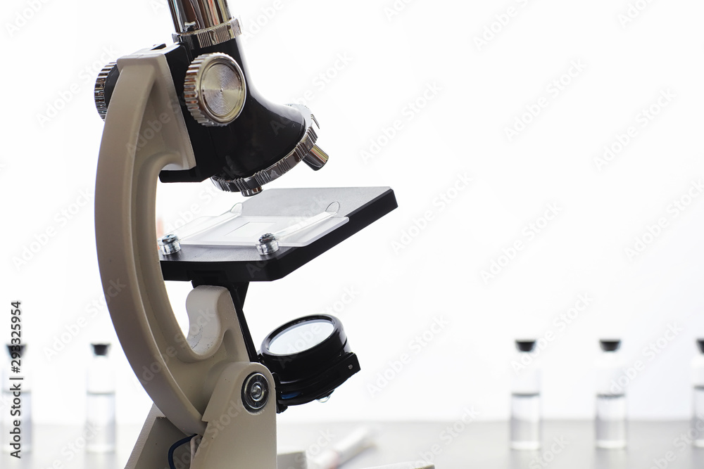 Research laboratory. Test tubes and microscope on the table on a white ...