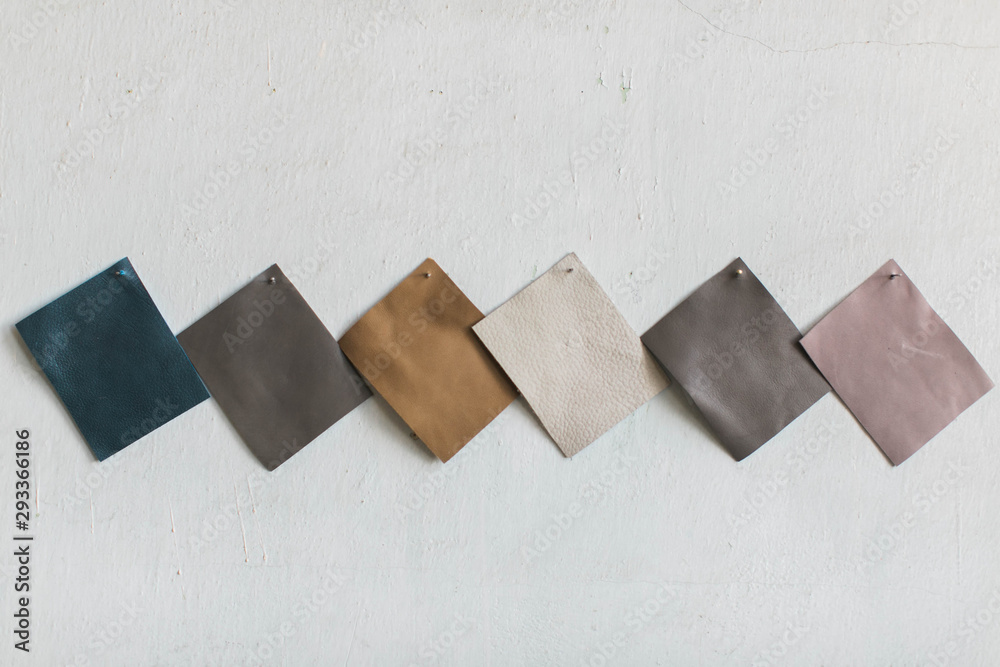 Neutral tone leather cowhide swatches on white wall, copy space Stock ...