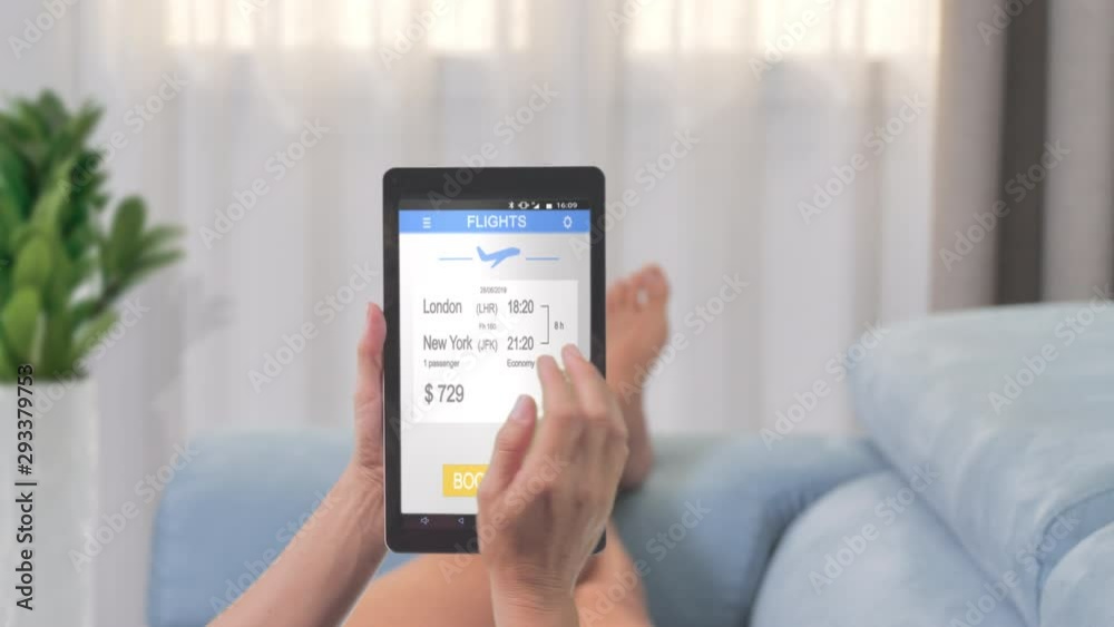 woman booking flight on her tablet Stock Video | Adobe Stock