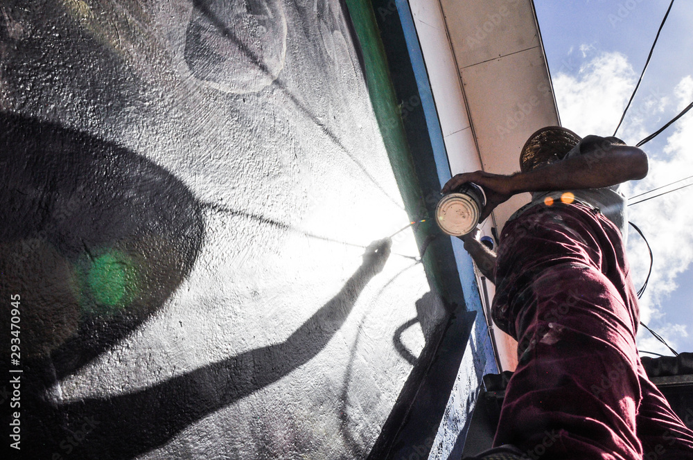 Silhoutte of a paintor doing a mural Stock Photo | Adobe Stock