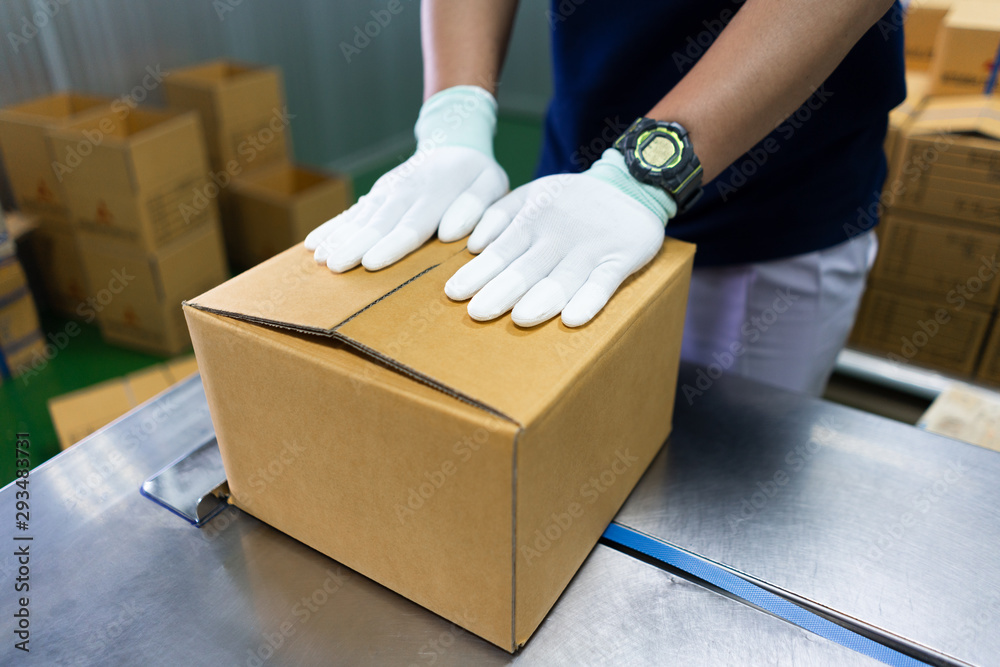 Man packing carton box in the packing room for safety goods in the ...