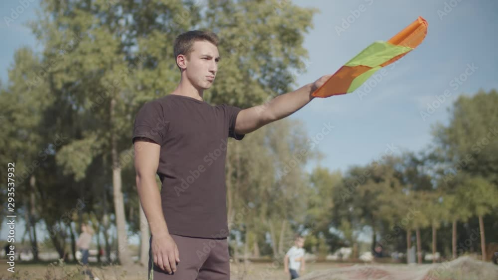 Portrait of confident determined assistant referee signalling for ...