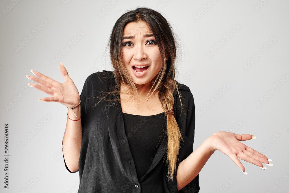 Portrait of perplexed Asian Kazakh girl with a dazed face expression ...