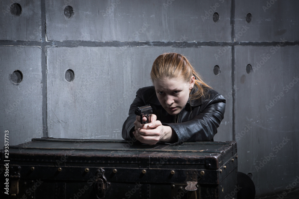 Hit woman. Biker girl in a black suit with gun in hand.. Stock Photo ...