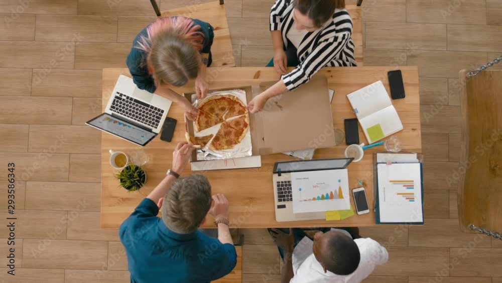 Top view of Lunch in Loft Office. Business Team of Hungry Young People ...