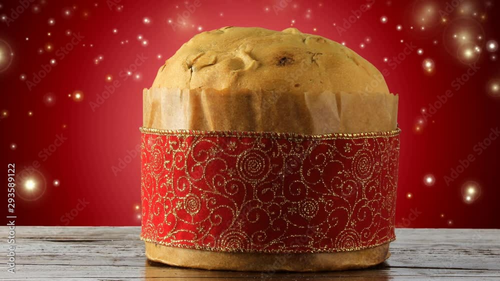 italian panettone over decorated christmas table, red background with ...