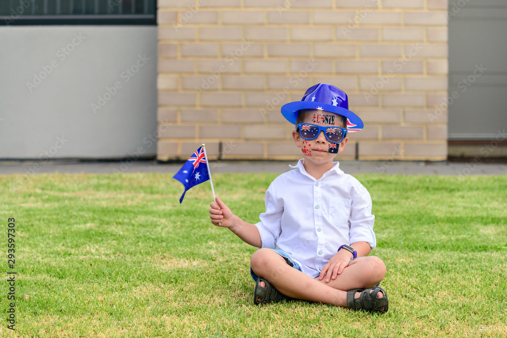 Cute Australian boy sitting on front yard on Australia Day Stock Photo ...