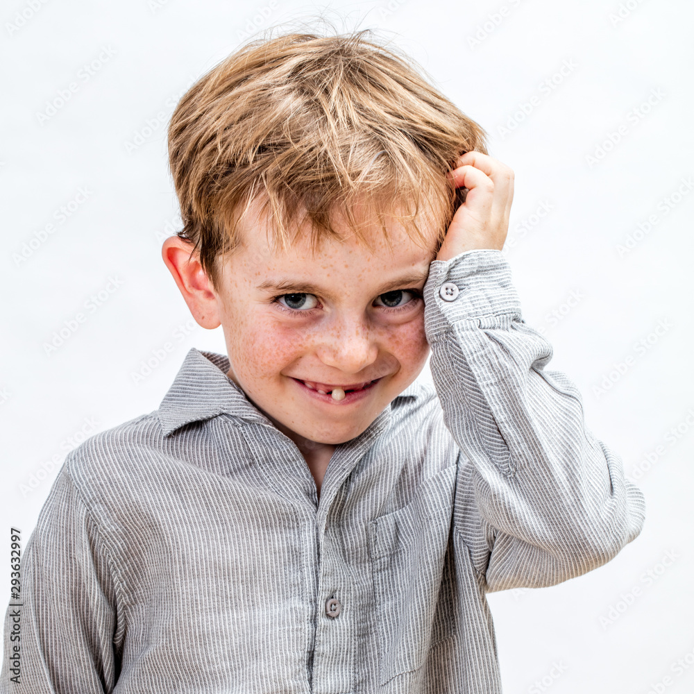 smiling child expressing shyness with his body language, isolated ...