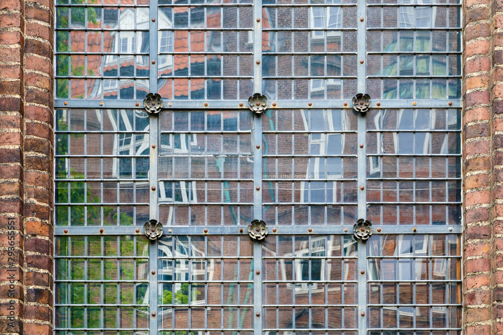 Large grid window on a vintage red brick building. Lot of small panes ...