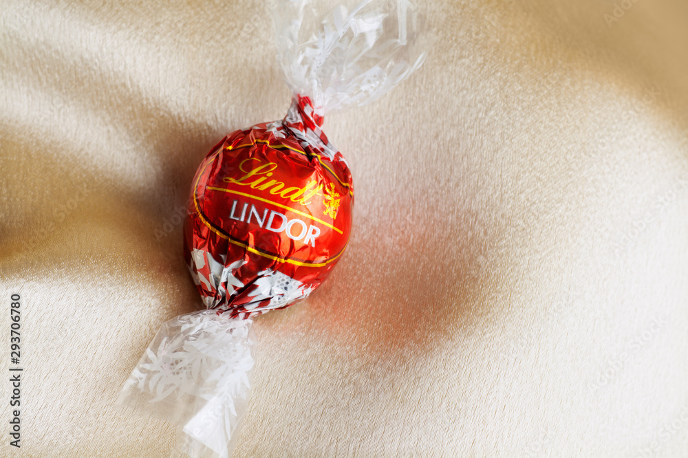 Lindt Chocolate bon bon by Lindor in red foil wrapper on silky smooth ...