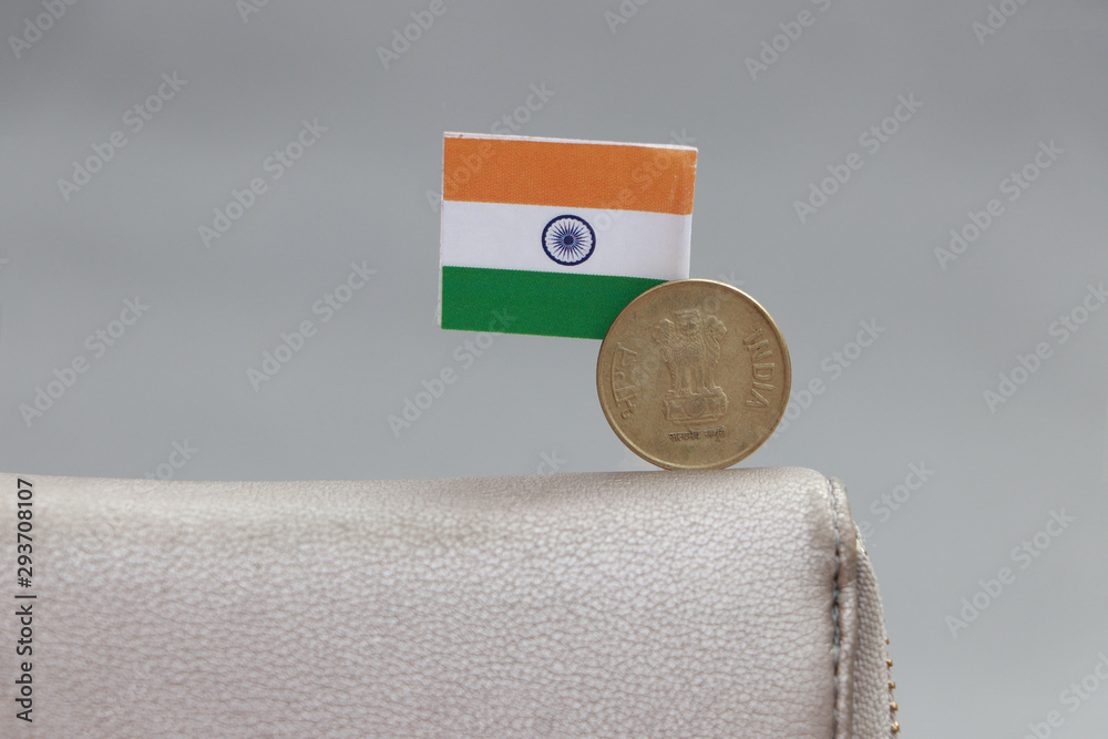 Five Rupee money coin of India and mini Indian flag stick on the ...