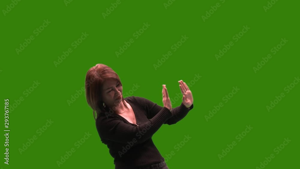 Asian female model on green screen waving with arms to the right to ...