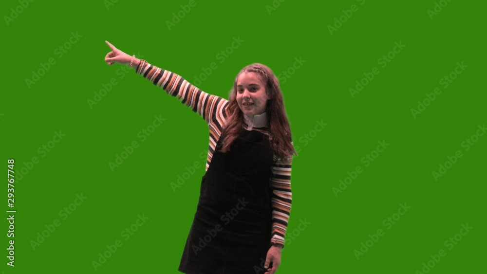 teenage girl model on green screen pointing left side up to approve ...