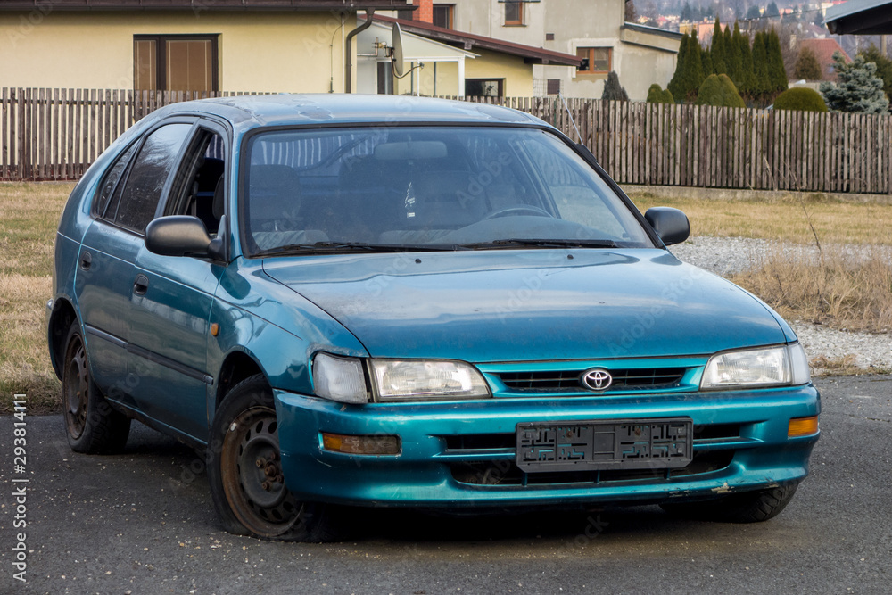 Abandoned azure blue Toyota Corolla hatchback car with a flat tire ...