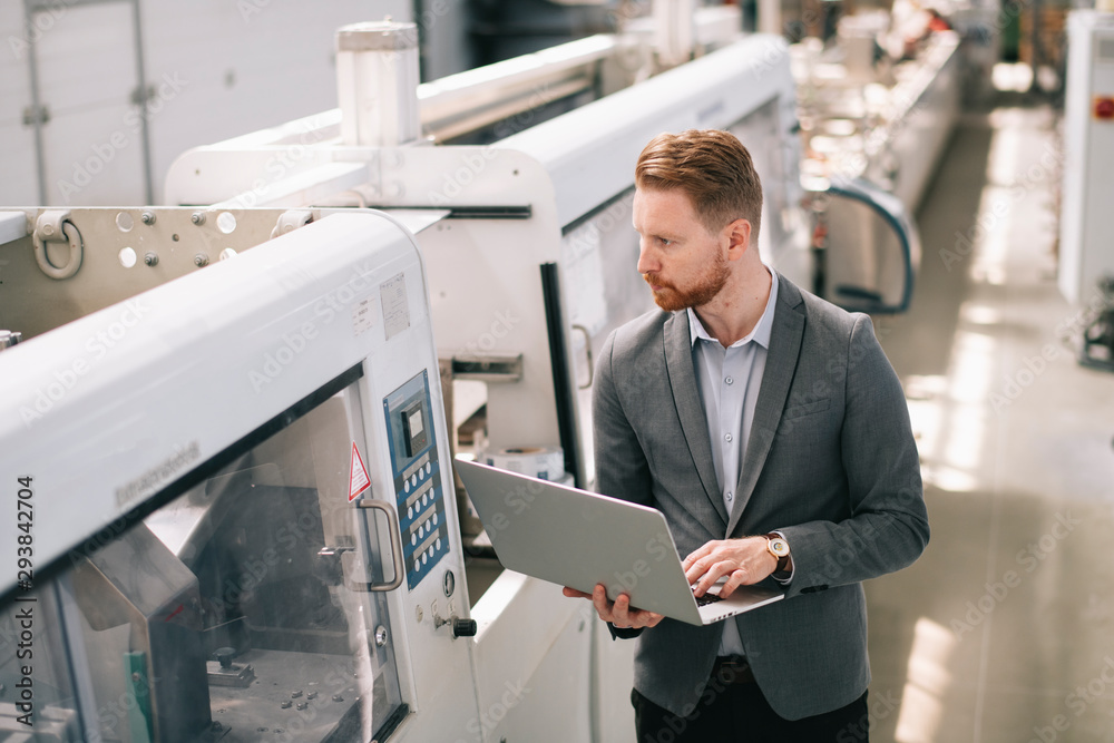 Manager checks machines at the factory. Inspector checks a factory ...