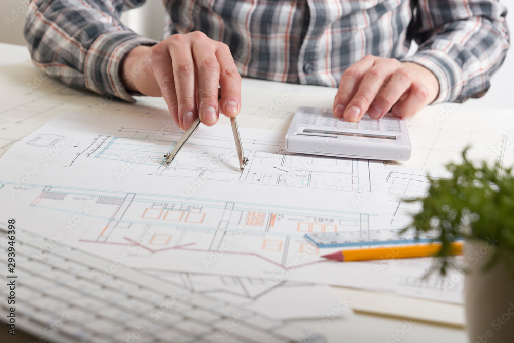 Architects working on blueprint, real estate project. Architect ...