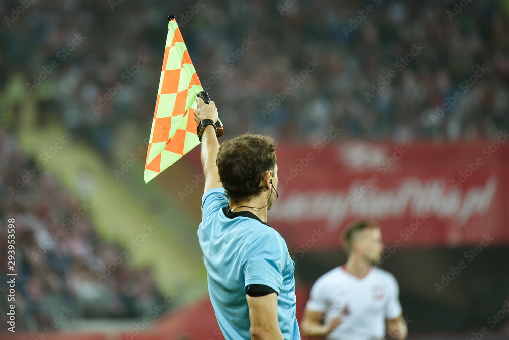 Assistant of football referee with raised flag. Stock Photo | Adobe Stock