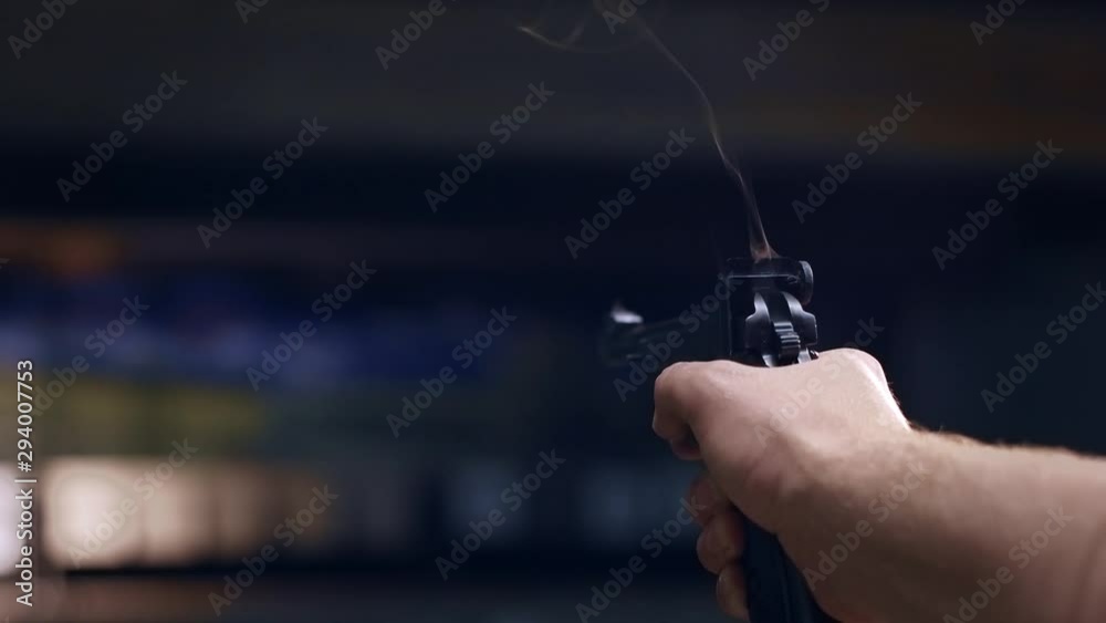 Shooting gallery. A young man preparing the gun and shooting with a ...