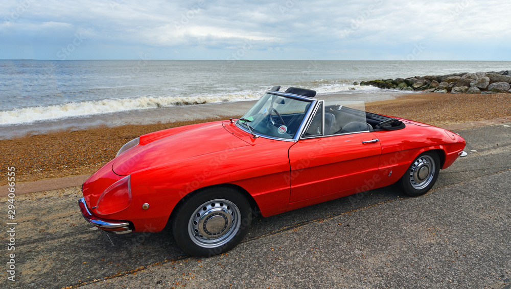 Classic red Alfa Romeo Sports Convertible Car parked on seafront ...