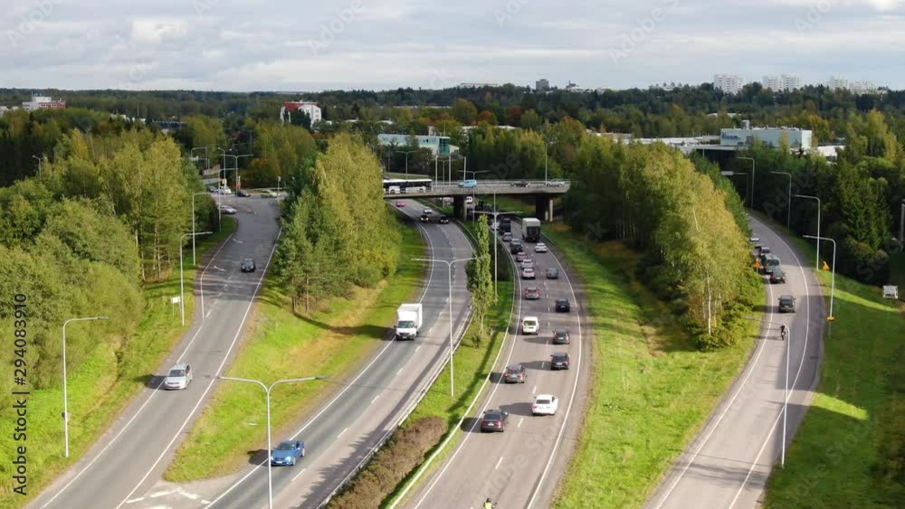 City traffic in a rush hour during the day. Cars driving slowly in a ...