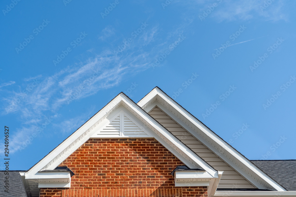 Double gable with beige horizontal vinyl lap and red brick facade ...