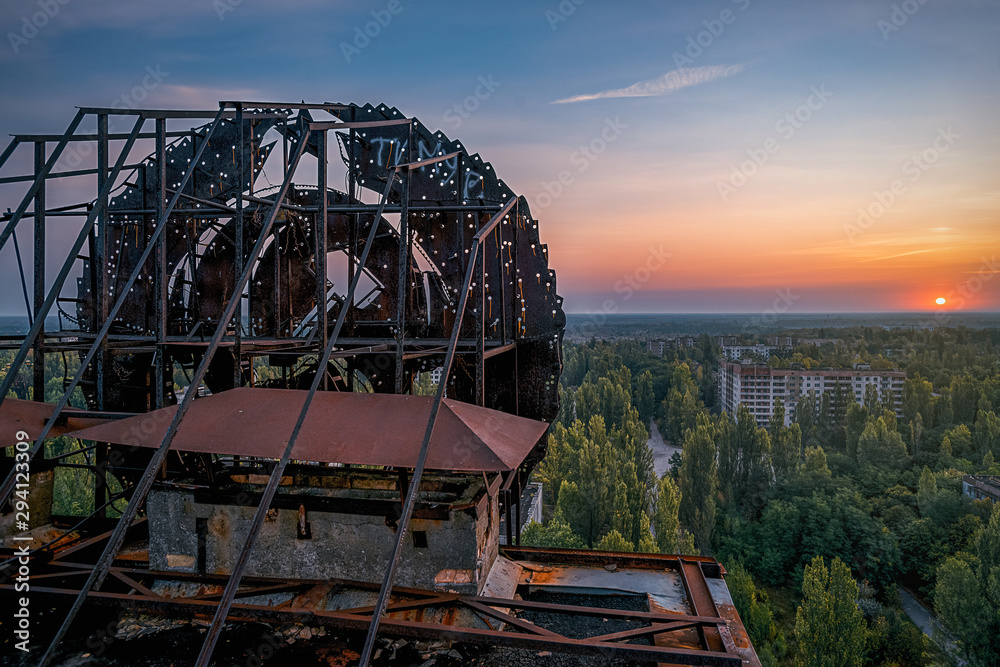 Soviet Union iron coat of arms in the dawn rays on the roof of a multi ...