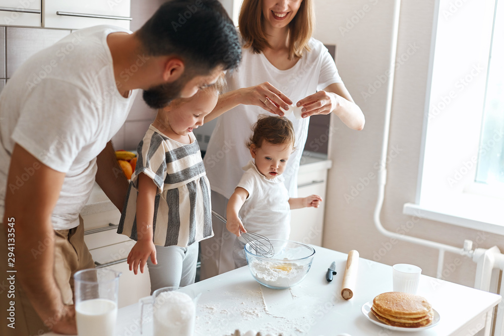parents teaching their children to do household chores, close up side ...