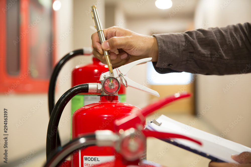 Engineer checking Pressure gauge of Fire extinguisher for fire,emergnce ...